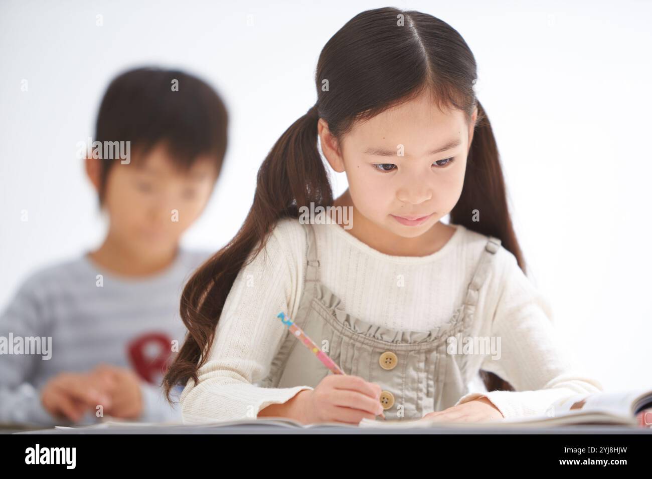 Male and female lower primary school pupils in class Stock Photo - Alamy