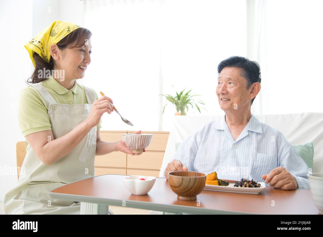 Carer feeding elderly hi-res stock photography and images - Alamy
