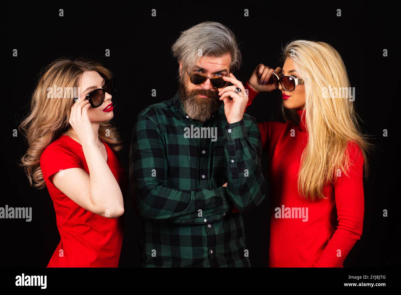 Group of fashion models posing in studio. Group of tree People. Friends ...