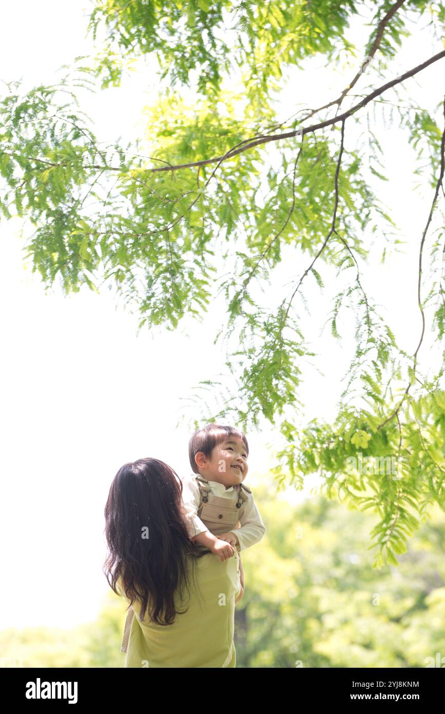 Mother lifting up her child Stock Photo - Alamy