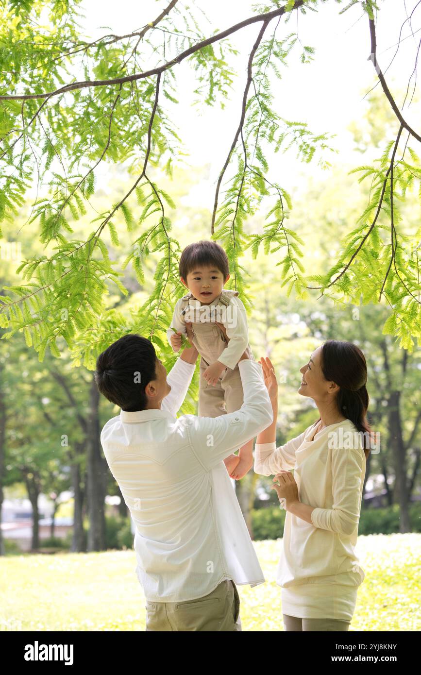 Parents lifting up child park hi-res stock photography and images - Alamy