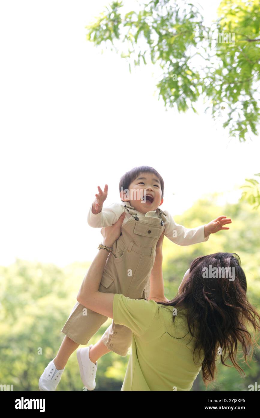 Mother lifting up her child Stock Photo - Alamy