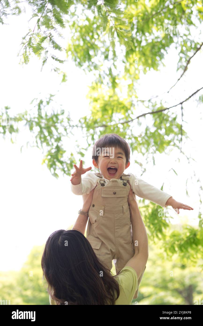 Mother lifting up her child Stock Photo - Alamy