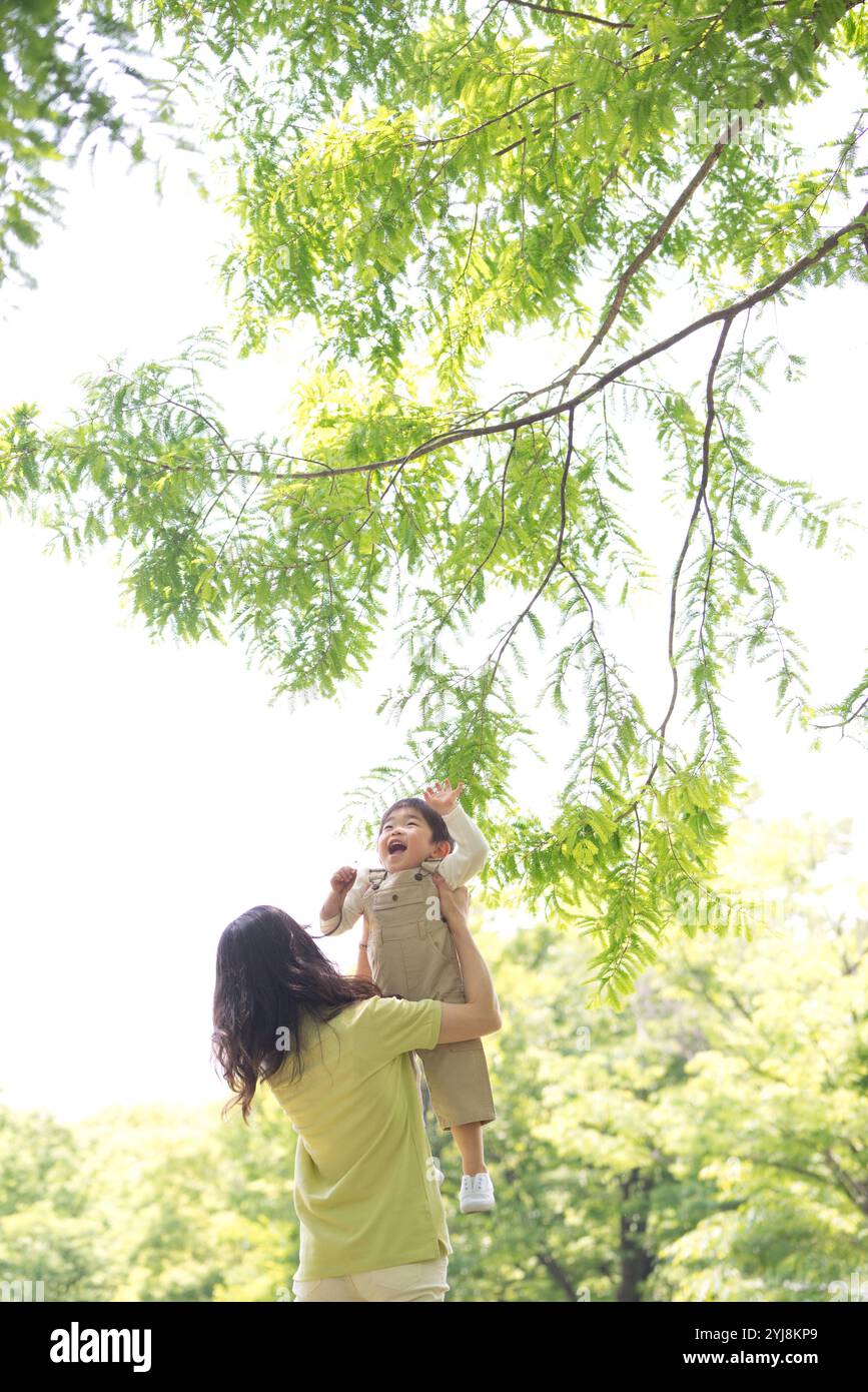 Mother lifting up her child Stock Photo - Alamy