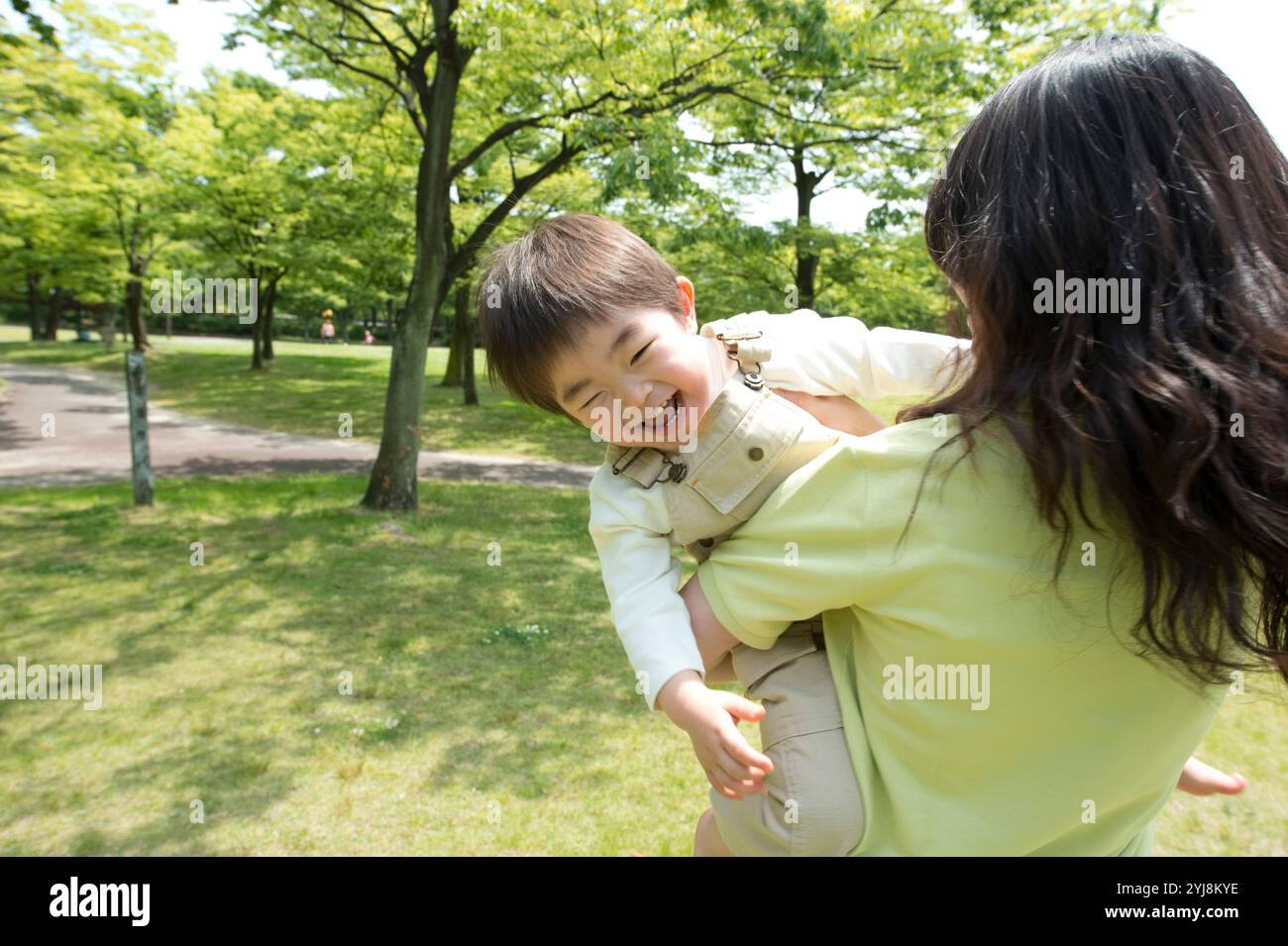 Woman lifting a boy Stock Photo - Alamy