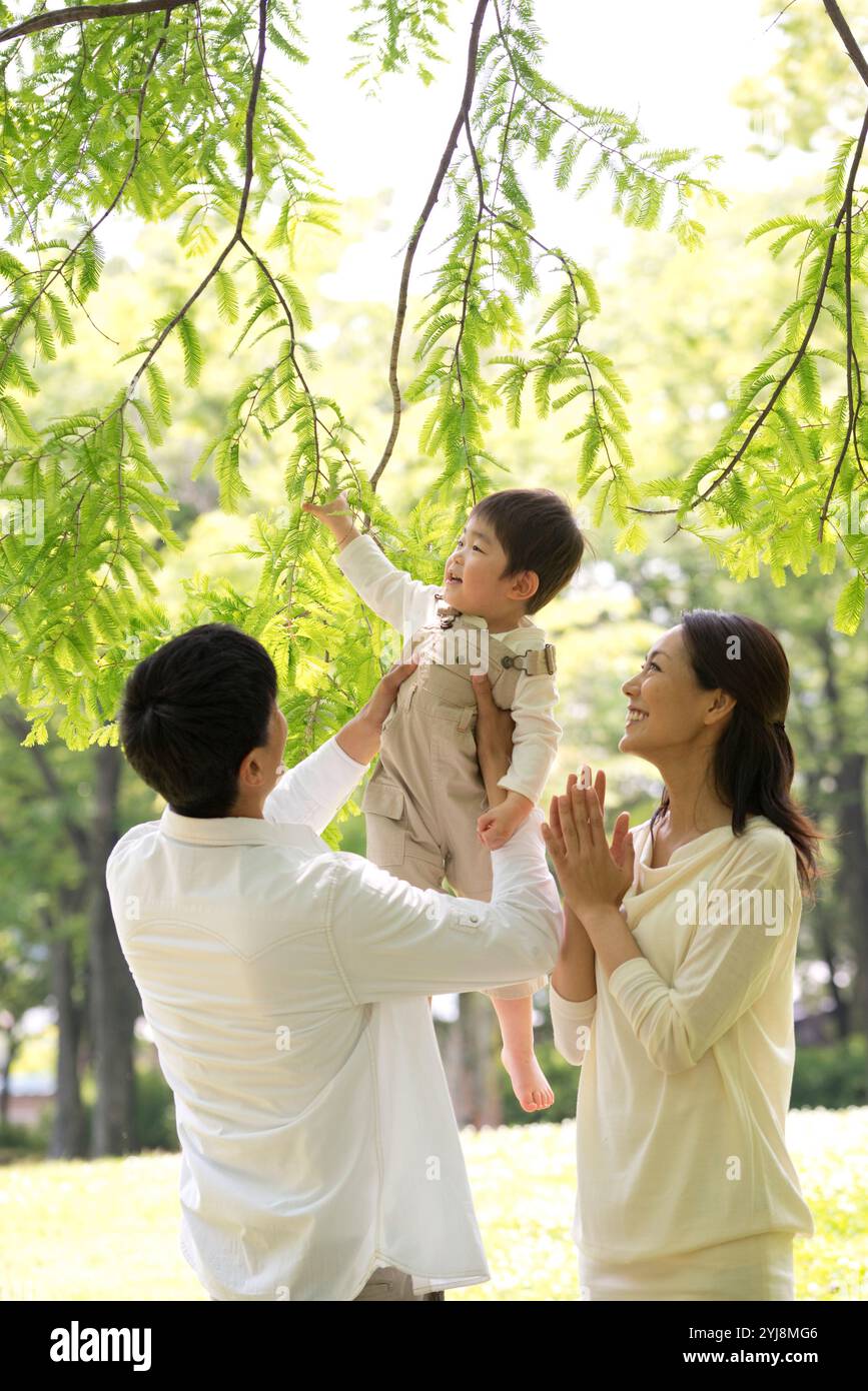 Parents lifting up child park hi-res stock photography and images - Alamy