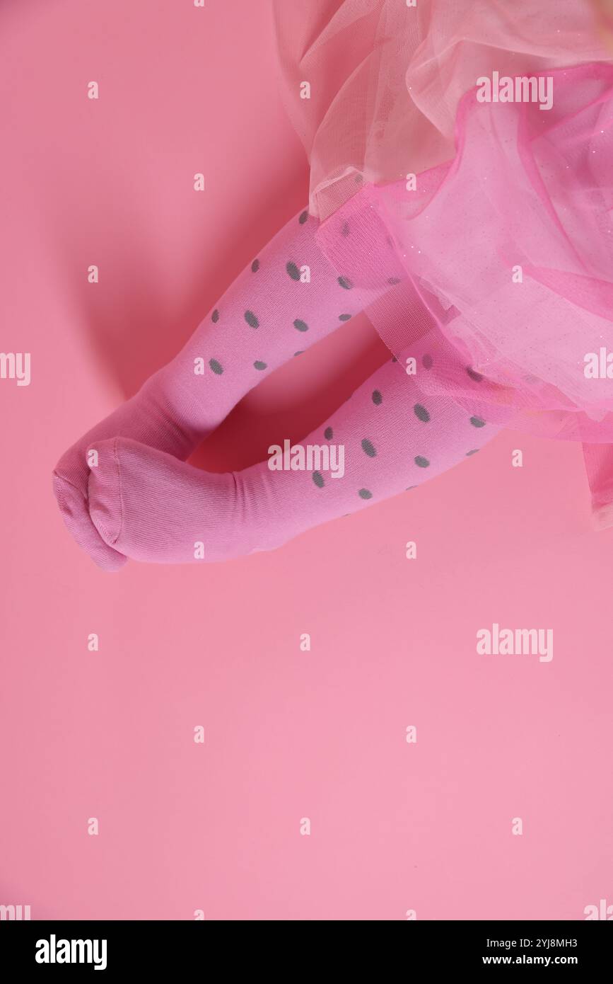 Child wearing tights on pink background, top view. Space for text Stock ...