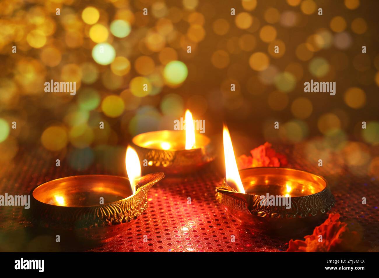 Diwali celebration. Diya lamps and beautiful flowers on golden ...