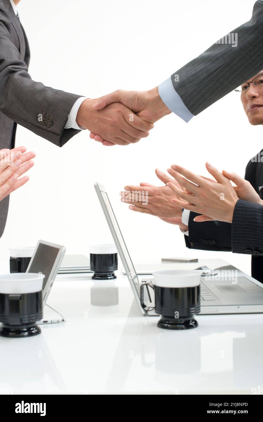 Businessperson clapping hands shaking hands Stock Photo - Alamy