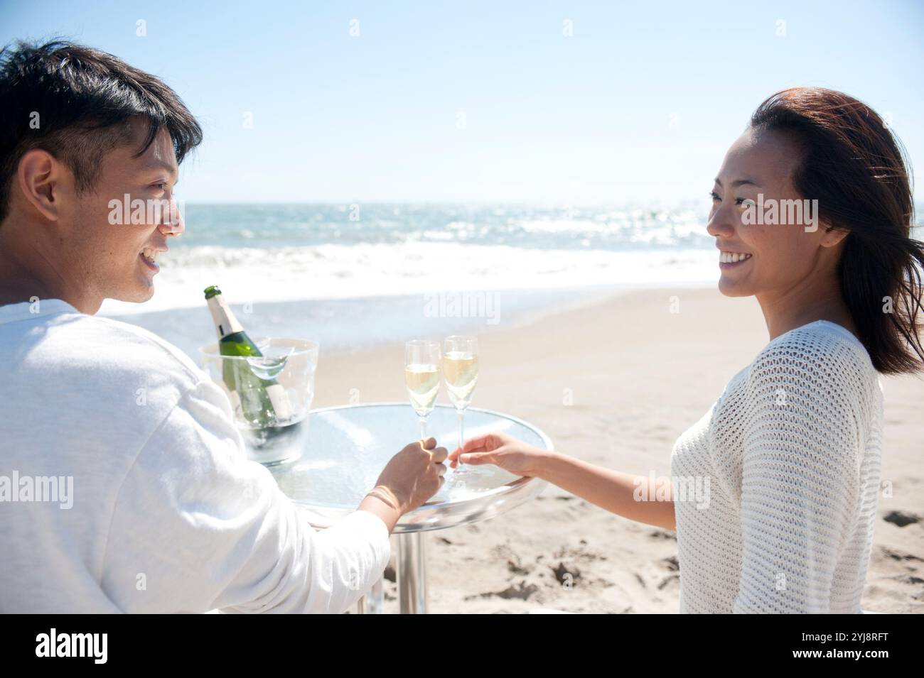 Couple drinking champagne on the beach Stock Photo - Alamy
