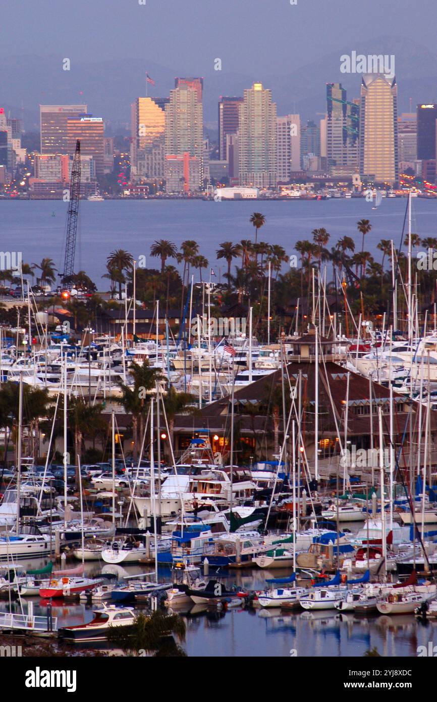 Sailboats and pleasure craft are moored at a marina within sight of the ...