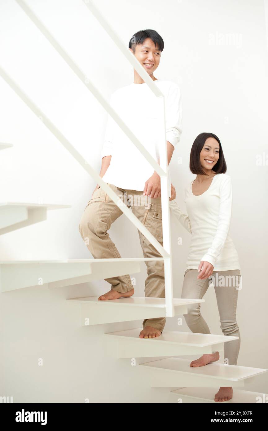 Two people going up the stairs hi-res stock photography and images - Alamy