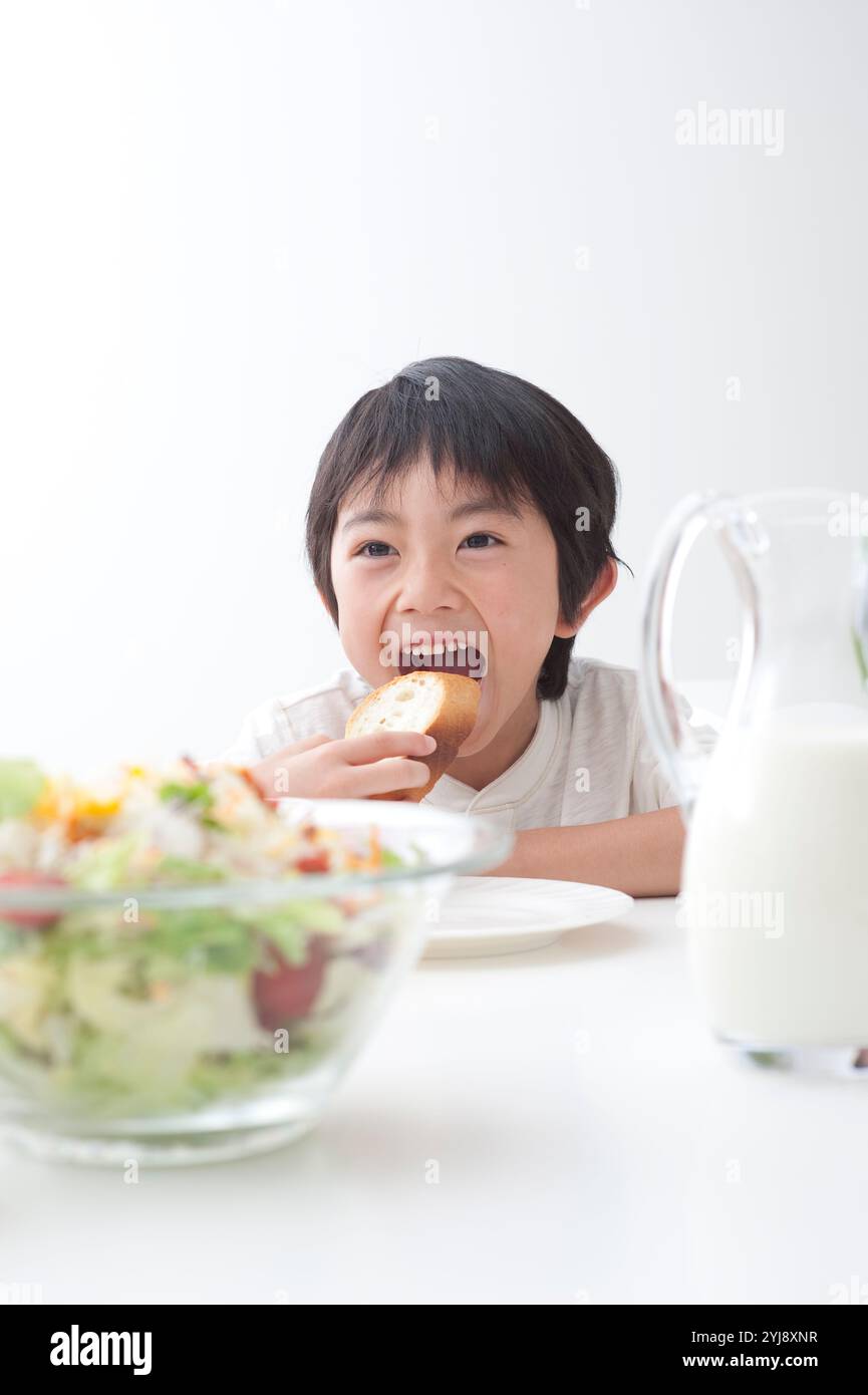 Boy at breakfast at the dining table Stock Photo - Alamy