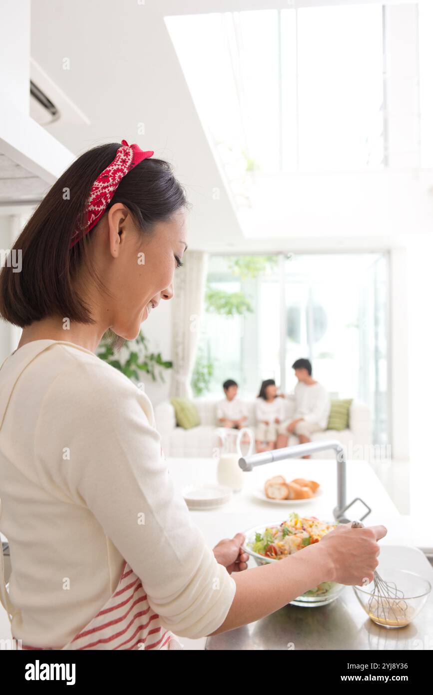 Woman cooking in kitchen, rear view Stock Photo - Alamy