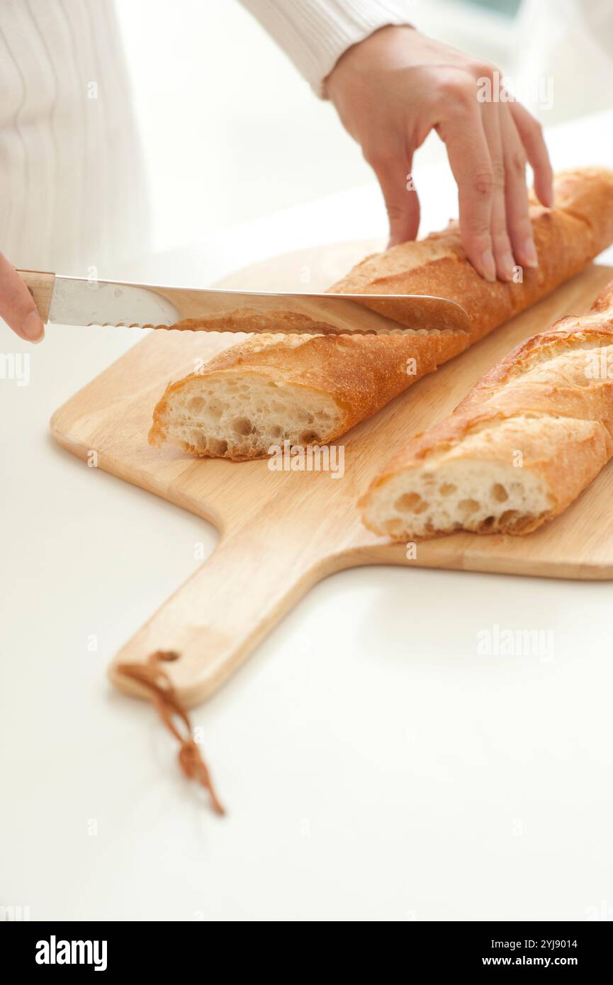 Hand cutting bread hi-res stock photography and images - Alamy