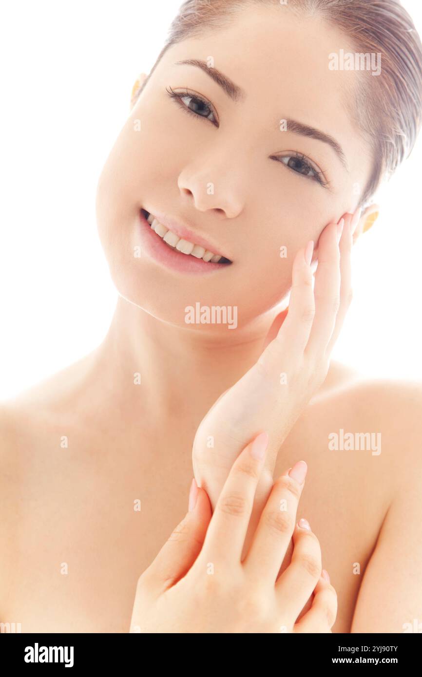 Beauty image of Japanese woman in her 20s patting her cheek Stock Photo ...