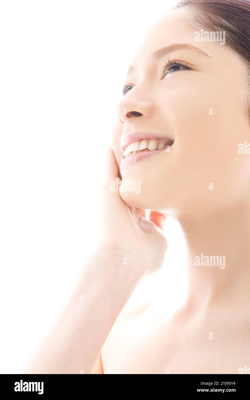Japanese woman in her teens patting her cheek Stock Photo - Alamy