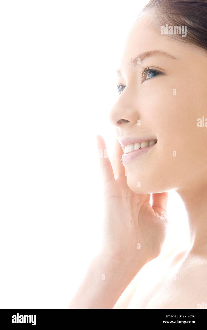 Japanese woman in her teens patting her cheek Stock Photo - Alamy