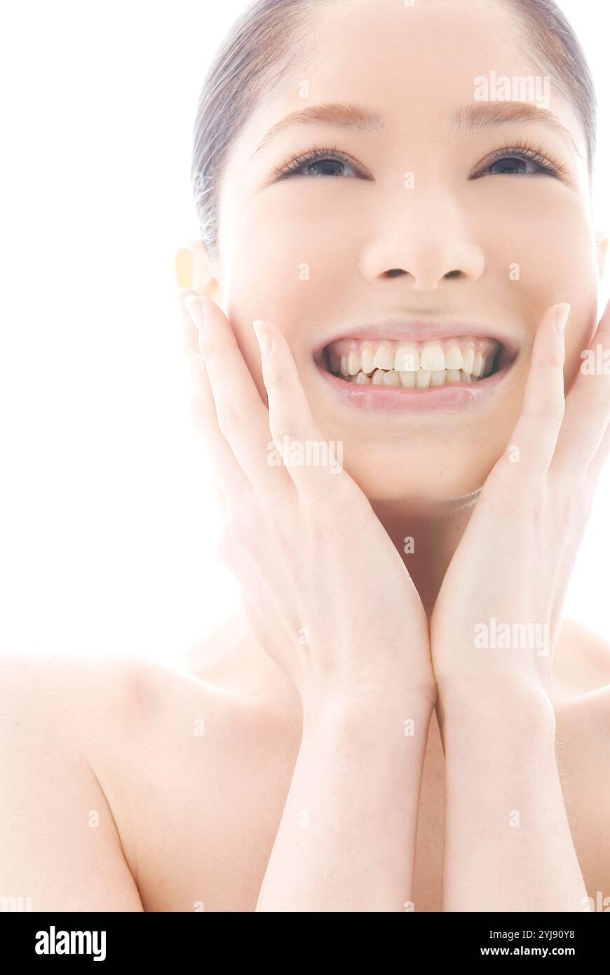 Japanese woman in her teens patting her cheek Stock Photo - Alamy