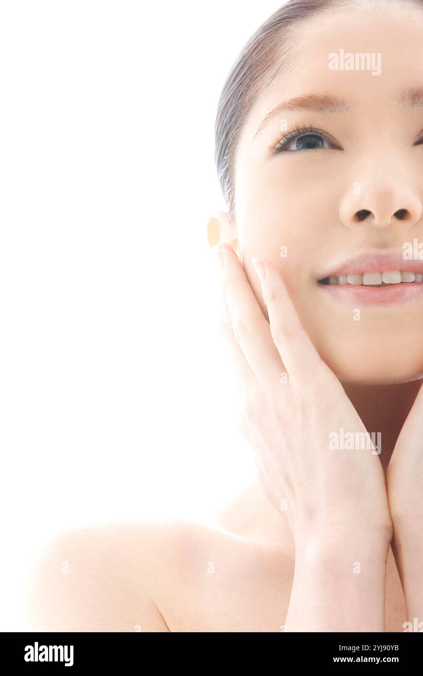 Japanese woman in her teens patting her cheek Stock Photo - Alamy