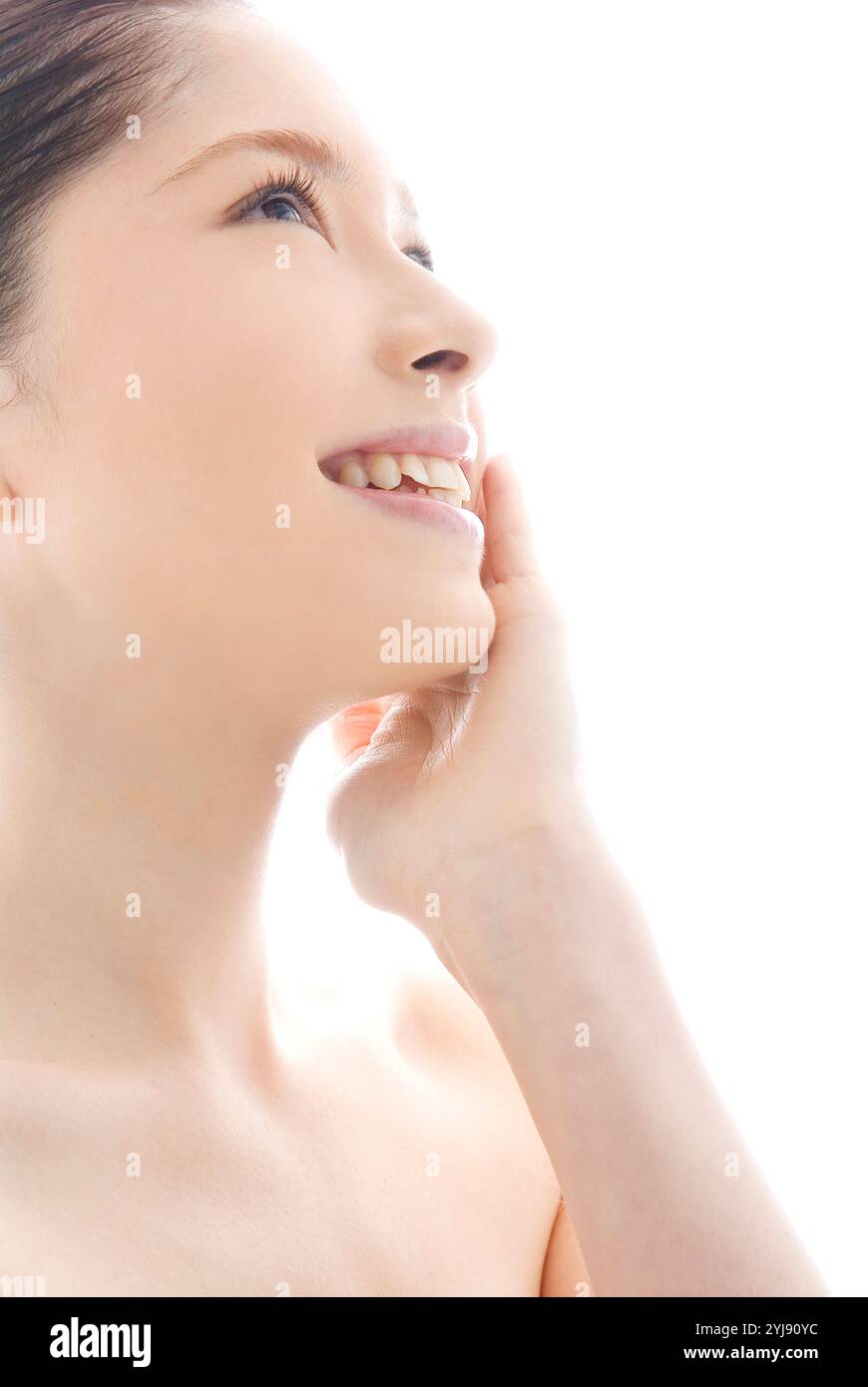 Japanese woman in her teens patting her cheek Stock Photo - Alamy