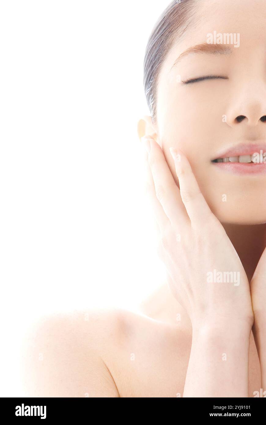 Japanese woman in her teens patting her cheek Stock Photo - Alamy