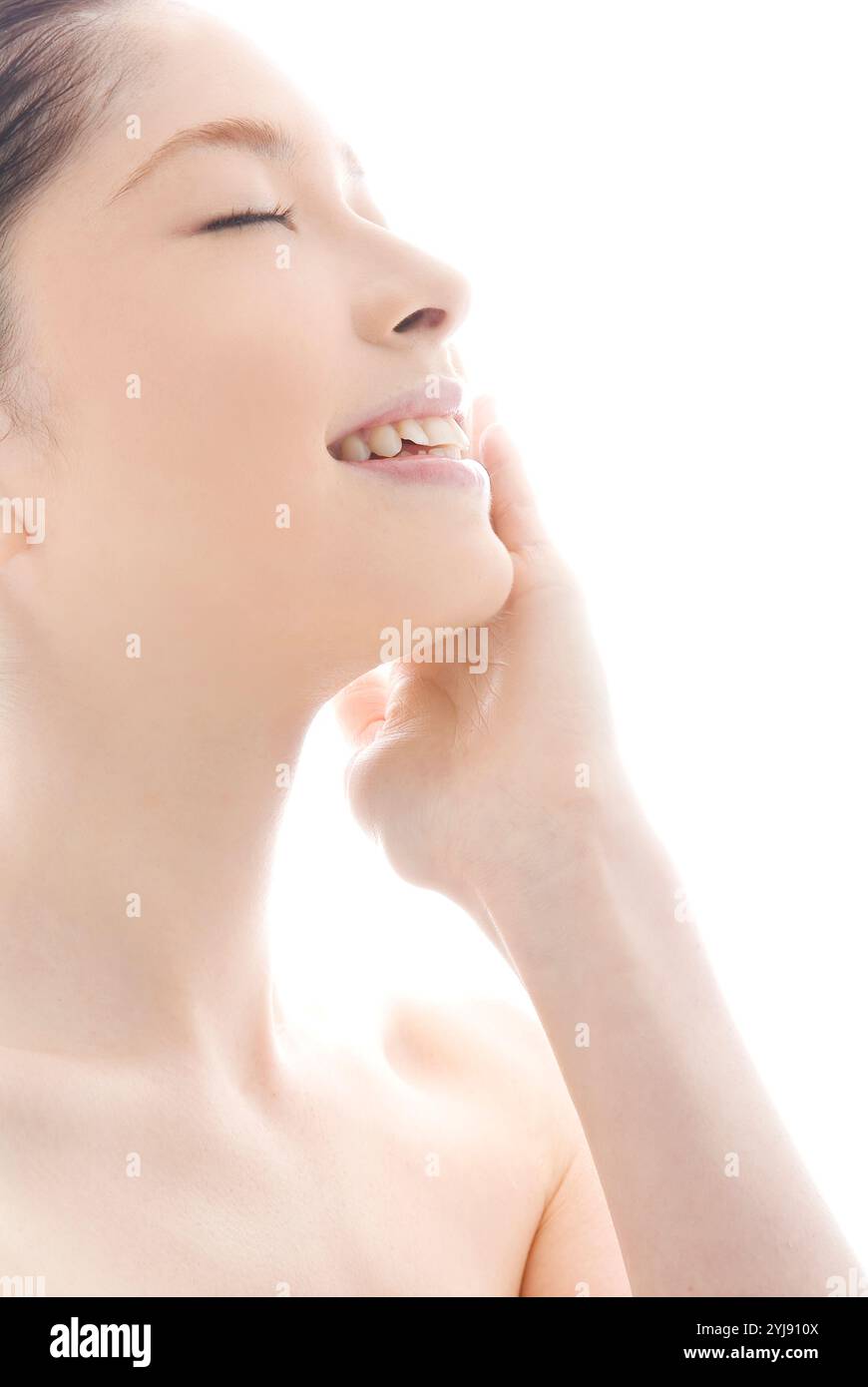 Japanese woman in her teens patting her cheek Stock Photo - Alamy