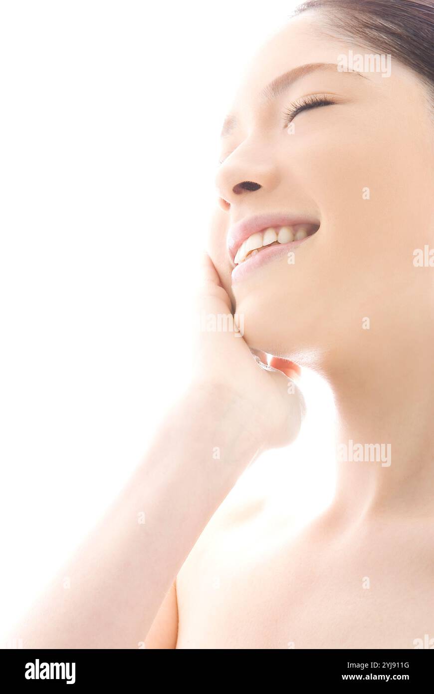 Japanese woman in her teens patting her cheek Stock Photo - Alamy