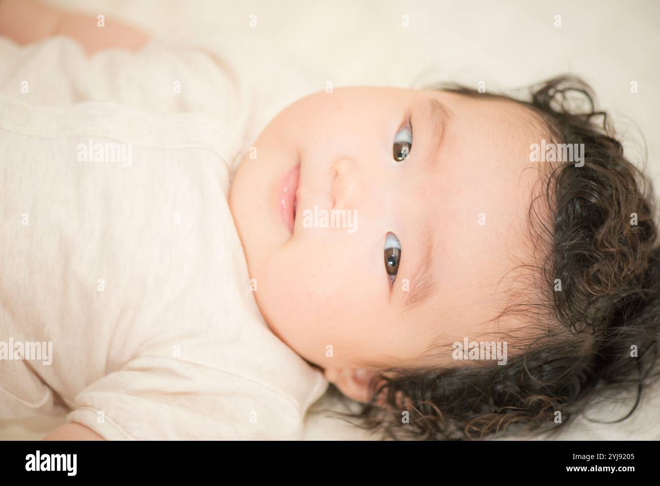 Seven-month-old baby staring at camera Stock Photo - Alamy