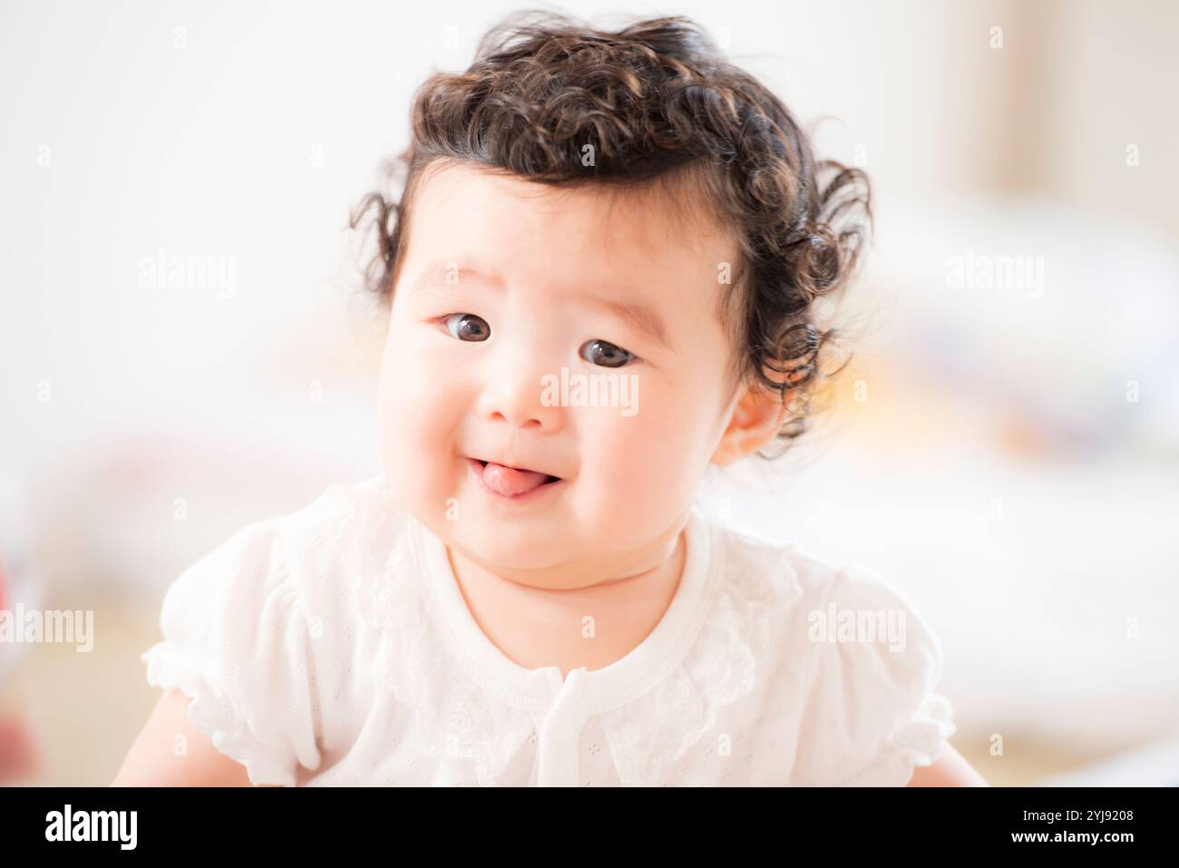 Six-month-old baby with tongue sticking out Stock Photo - Alamy