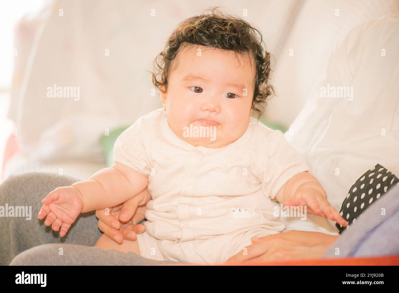 Five-month-old baby sitting on mother's lap Stock Photo - Alamy