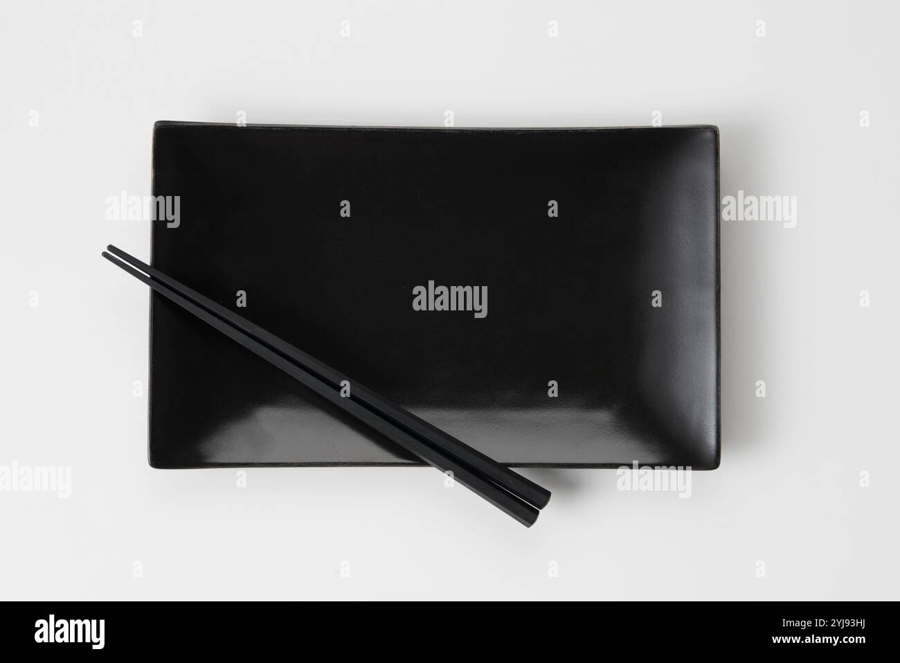 Plate and chopsticks on white background Stock Photo - Alamy