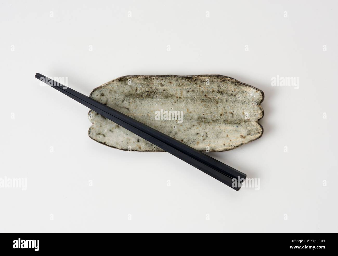 Plate and chopsticks on white background Stock Photo - Alamy