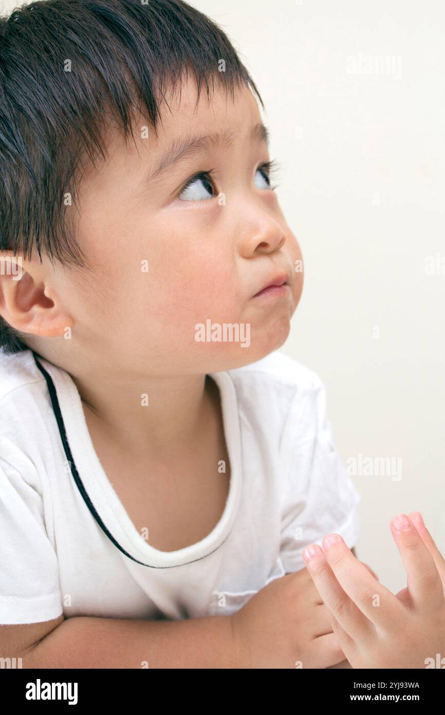 Disgruntled 3-year-old boy, profile, bulging face Stock Photo - Alamy