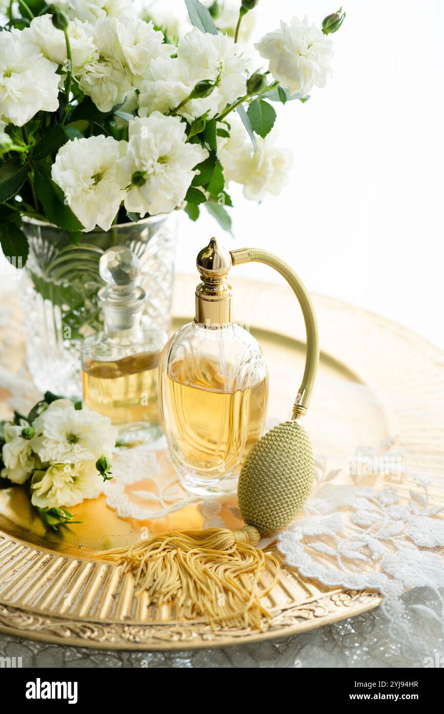Classic perfume bottle and white roses Stock Photo - Alamy