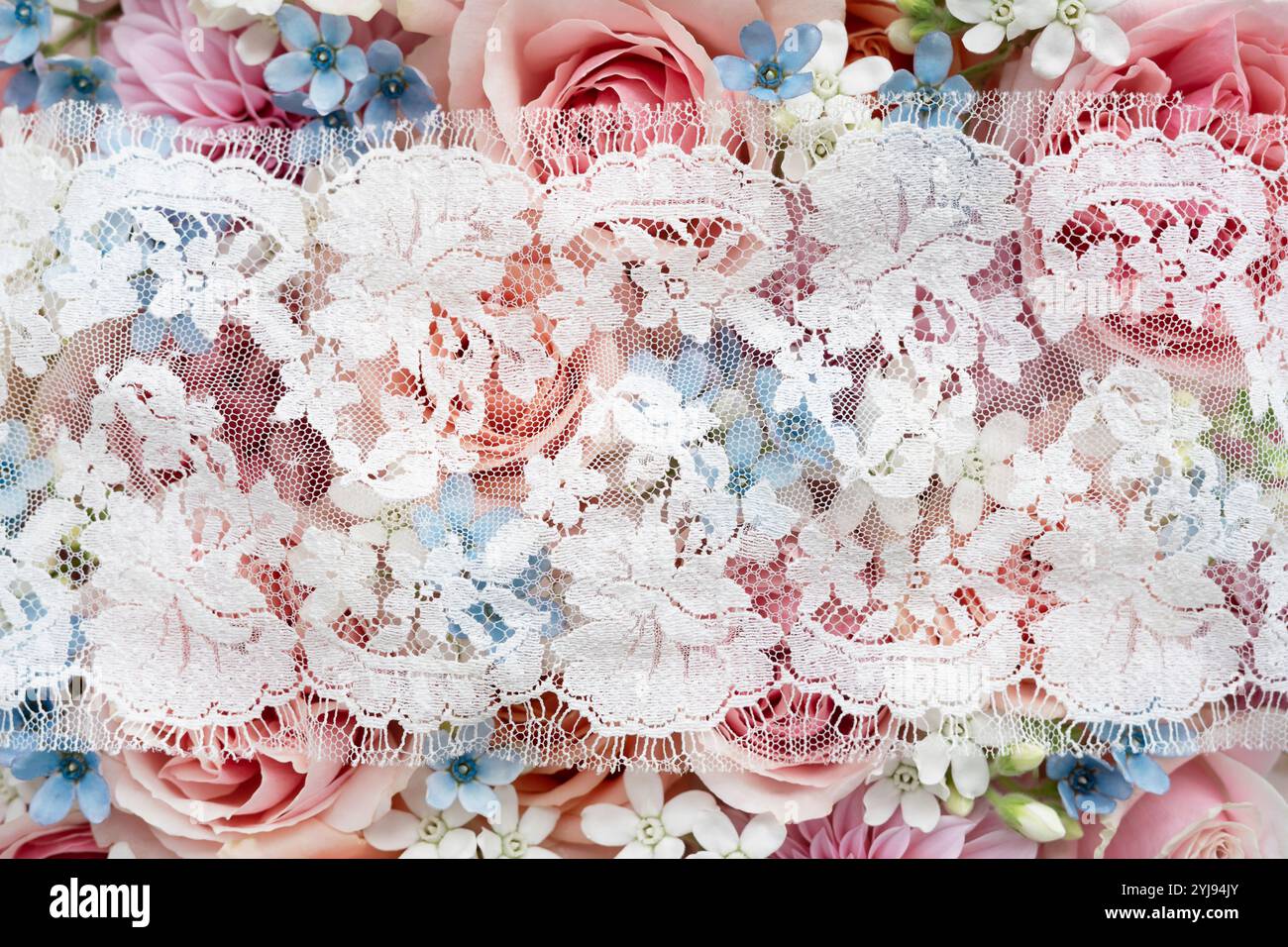 Lace on top of colourful flower arrangement Stock Photo - Alamy
