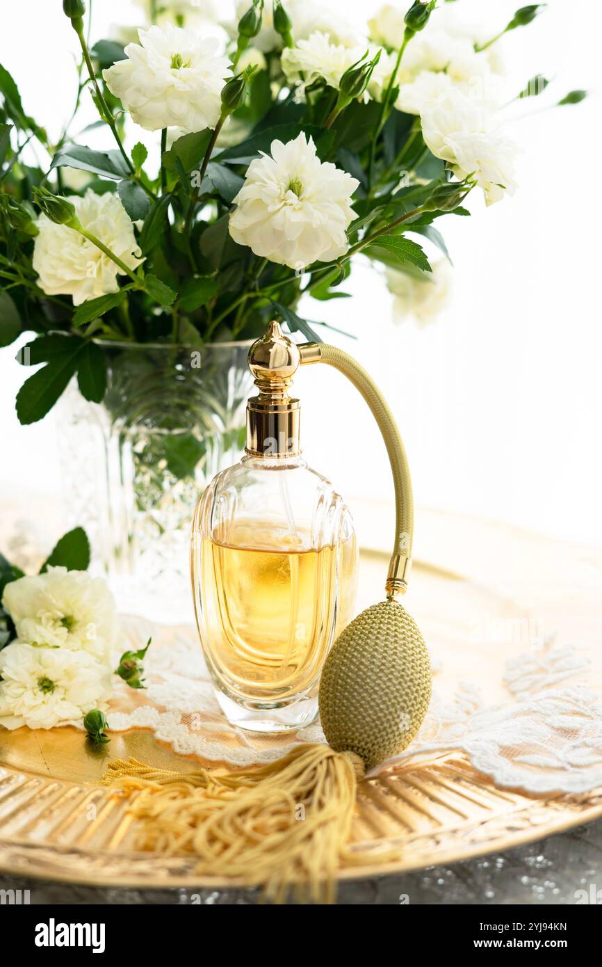 Classic perfume bottle and white roses Stock Photo - Alamy