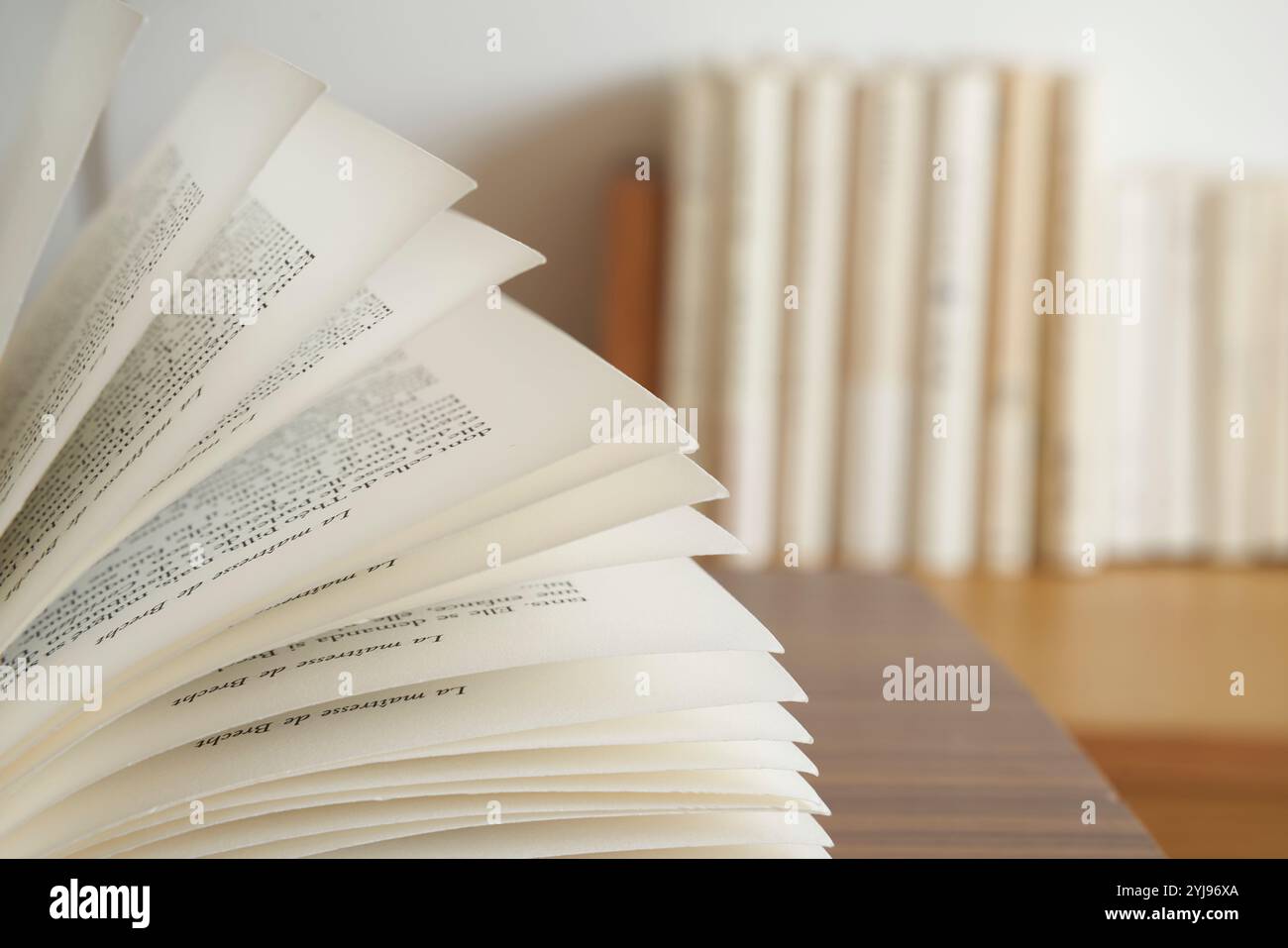 Book with pages turned over on desk Stock Photo - Alamy