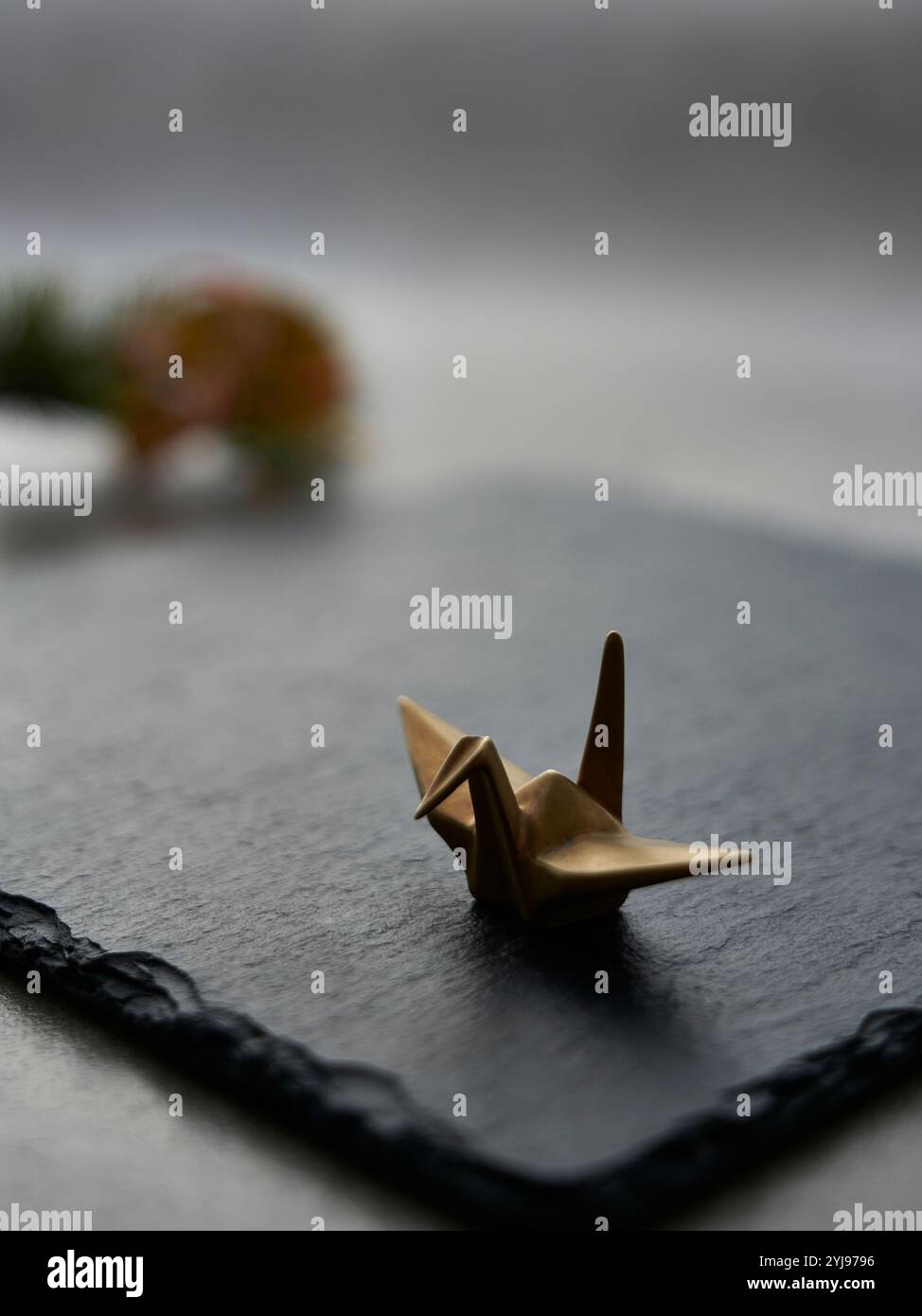 Golden crane on black stone slab Stock Photo - Alamy
