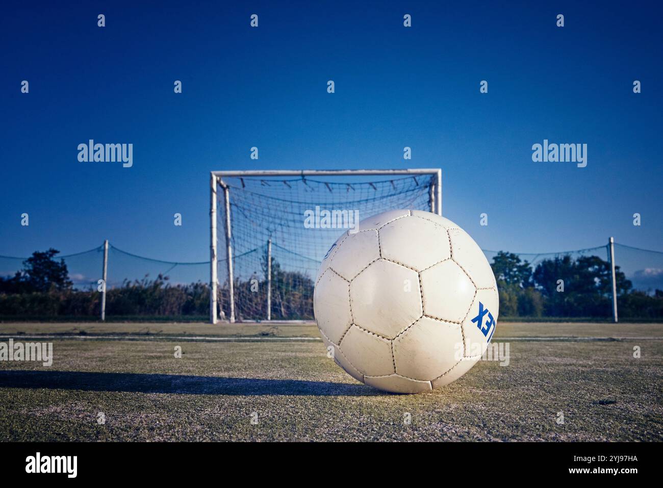 Football ball and goal net on court Stock Photo - Alamy
