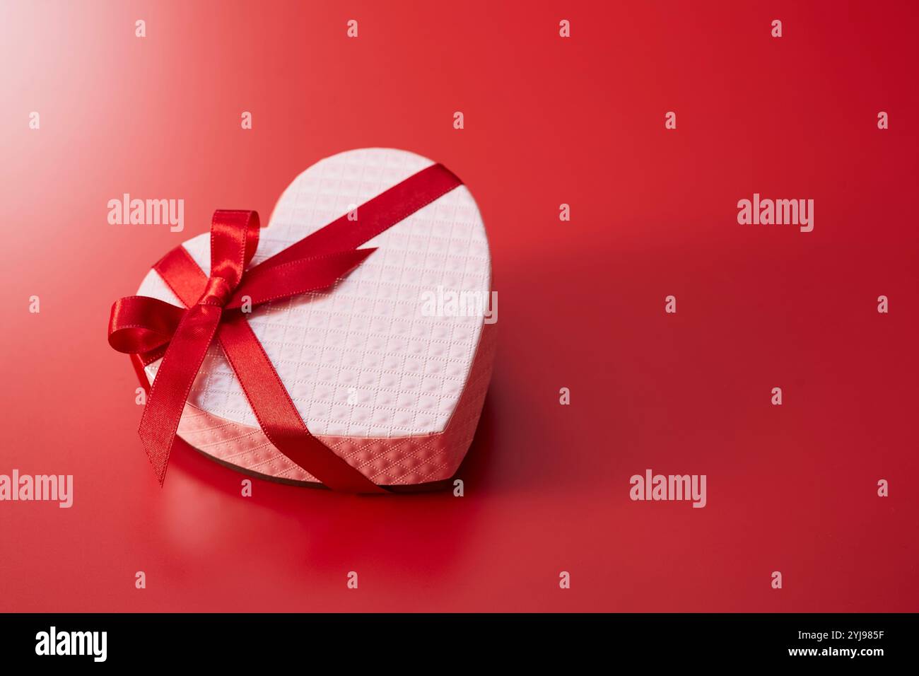 Heart-shaped box with ribbon Stock Photo - Alamy