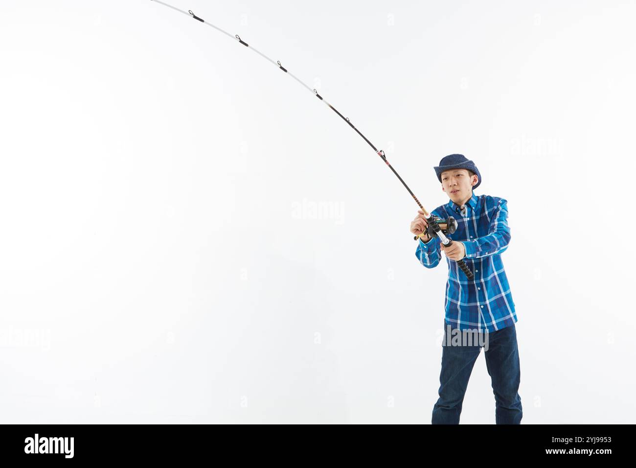 Man wearing hat feeling fishing rod flexing and responding Stock Photo ...