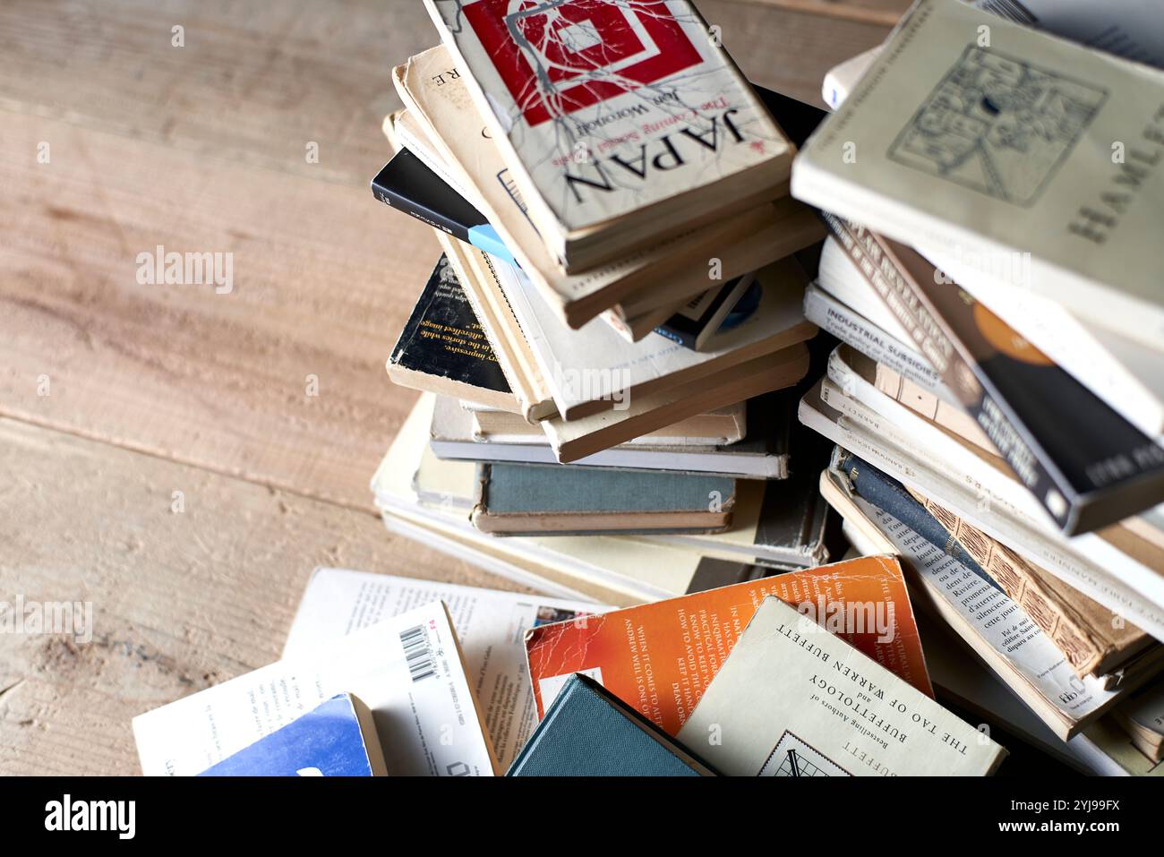 Piles of books on the floor Stock Photo - Alamy