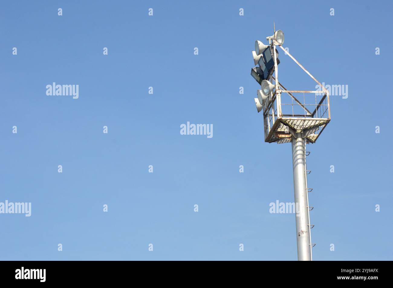stadium light poles with blue sky backgrounds Stock Photo - Alamy