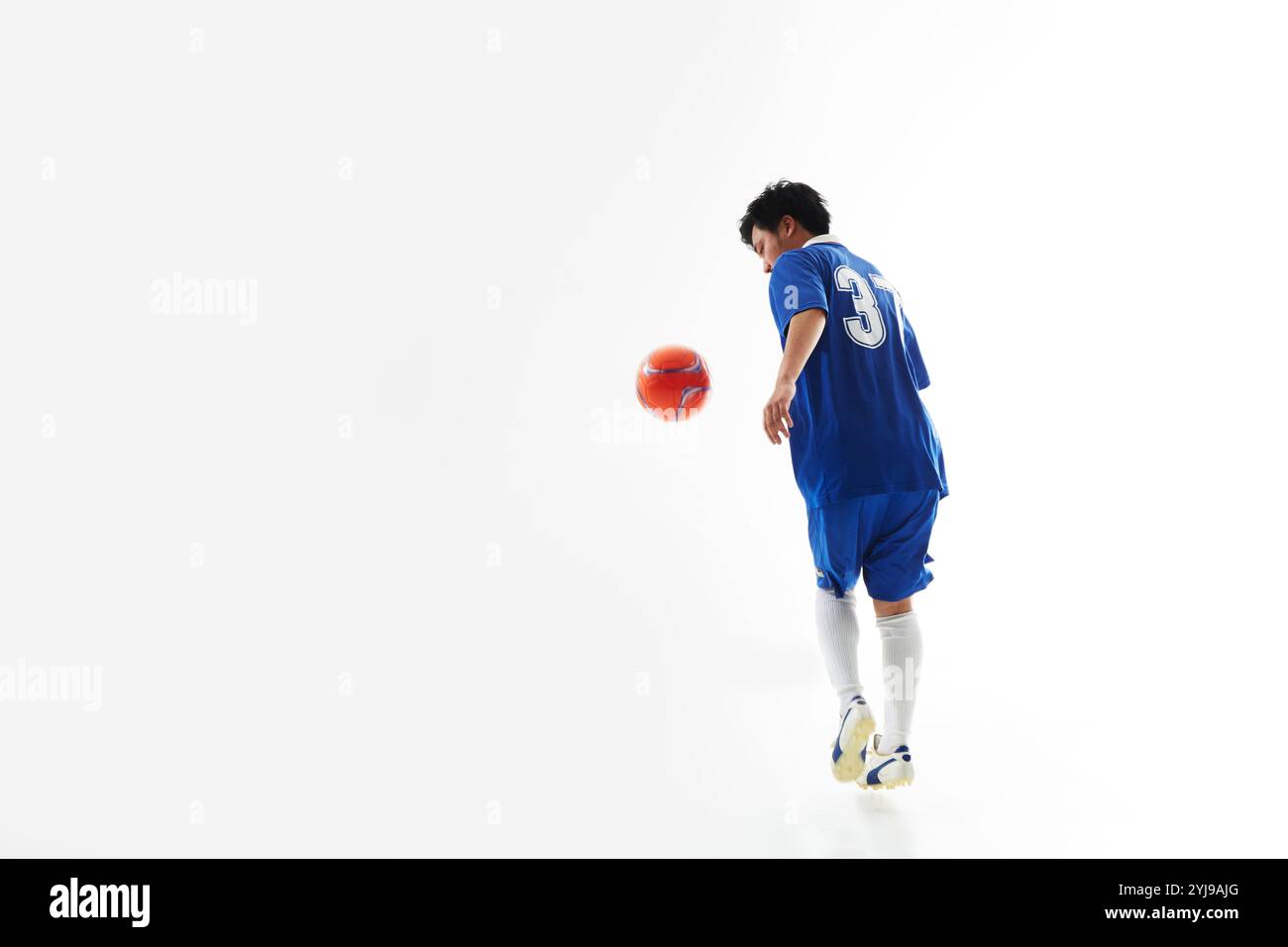 Footballer chasing the ball Stock Photo - Alamy