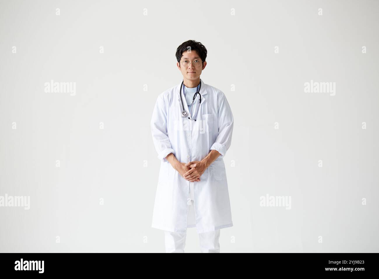Male doctor folded hands hi-res stock photography and images - Alamy