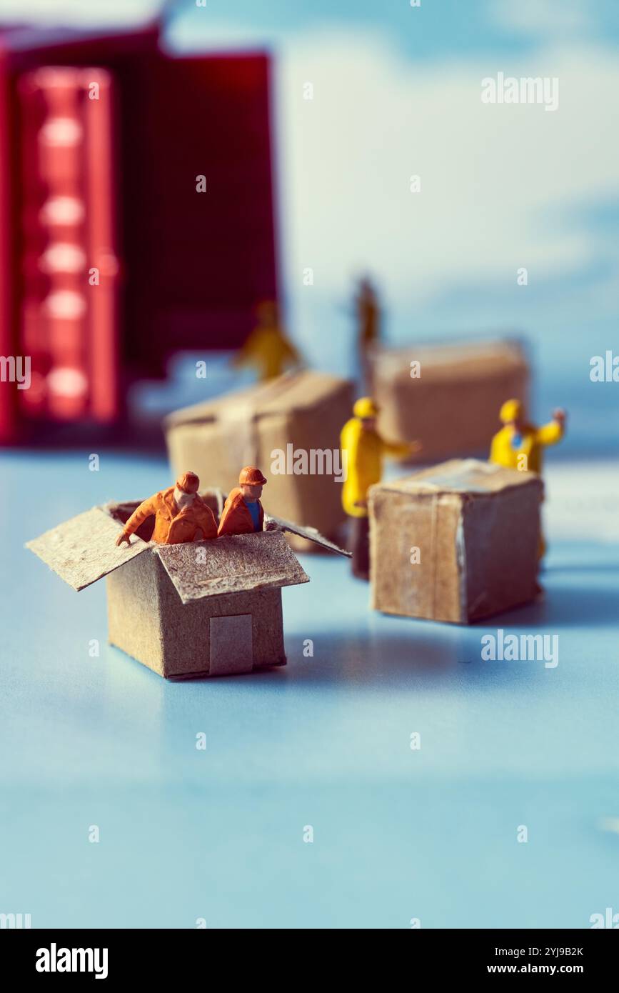Miniature people carrying cardboard boxes Stock Photo - Alamy