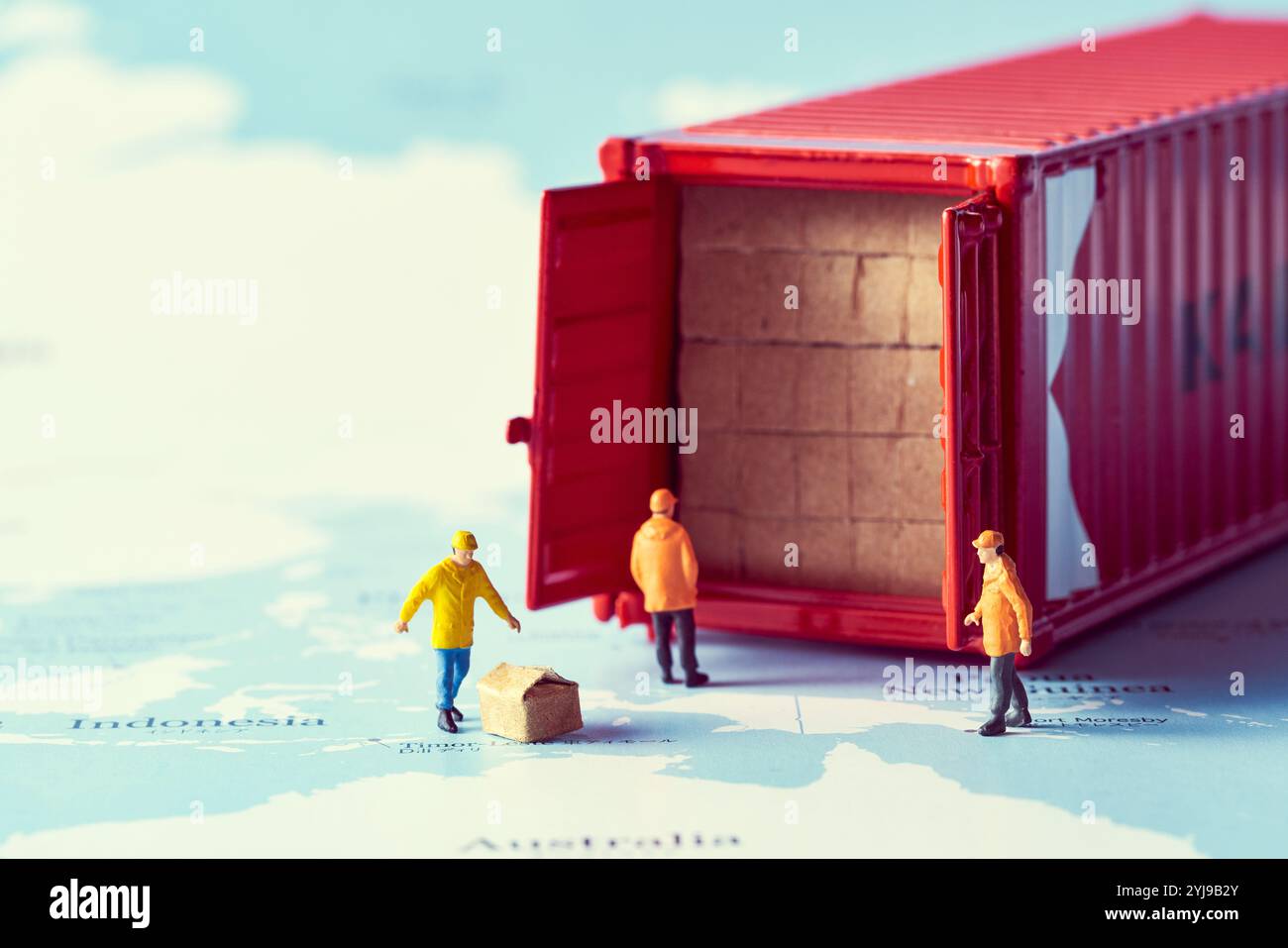 Miniature dolls stuffing cardboard into miniature containers Stock ...