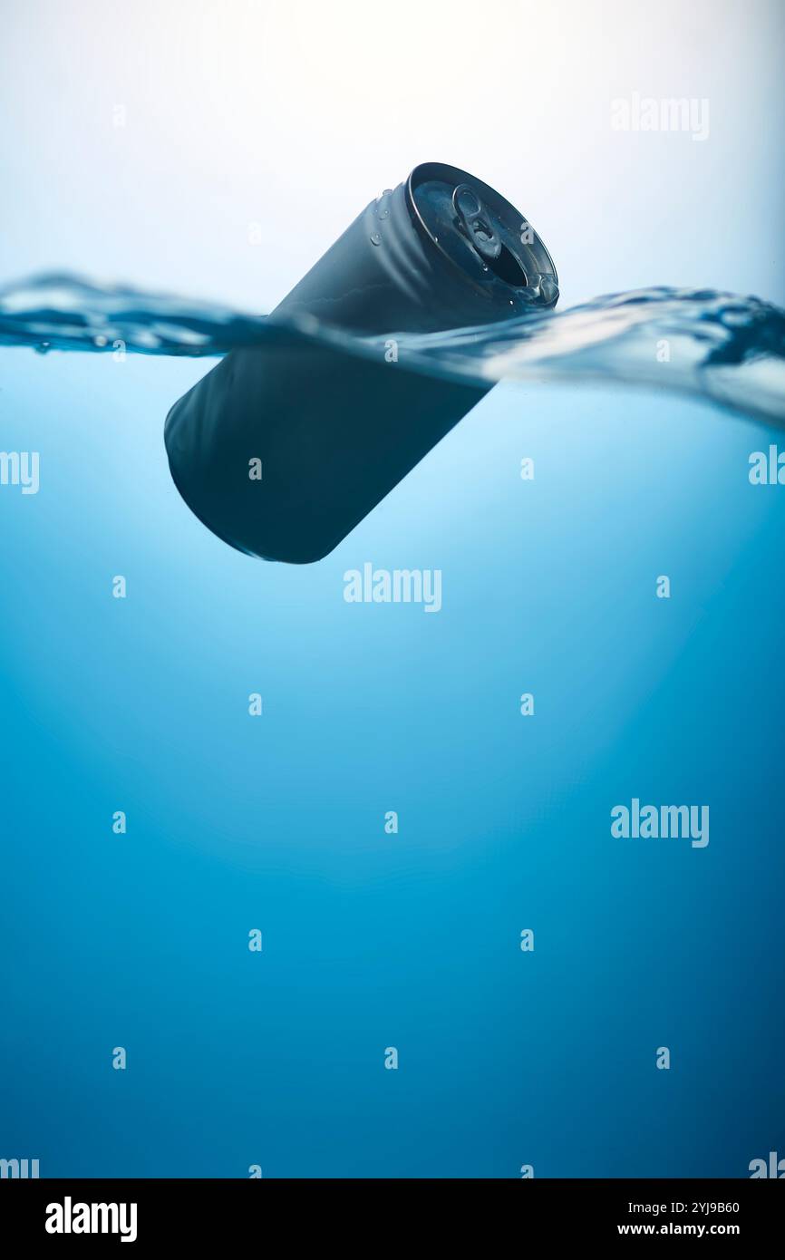 Empty cans floating on water Stock Photo - Alamy