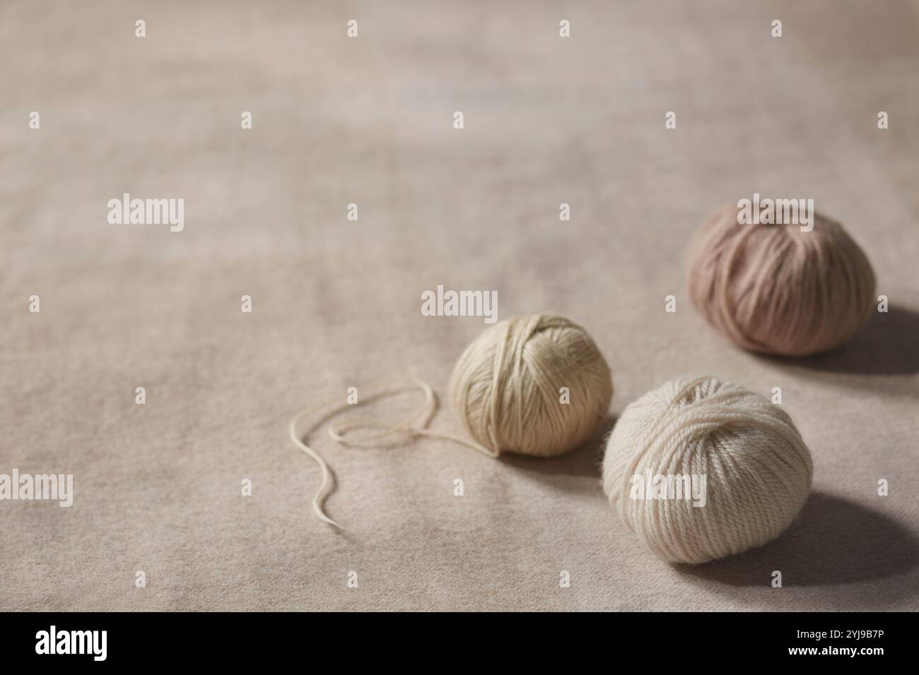 Three rolling balls of yarn Stock Photo - Alamy